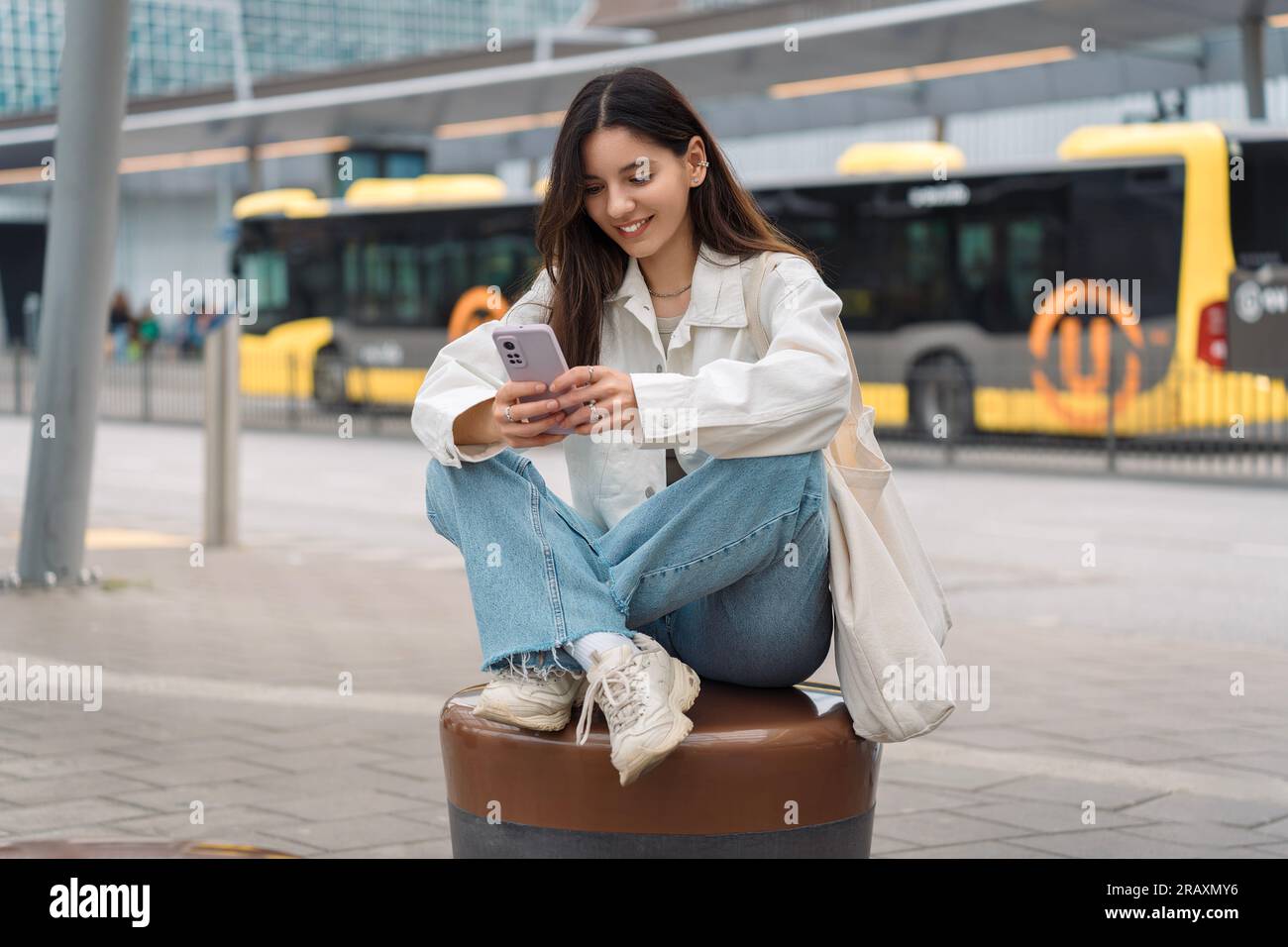 Checking public transport timetable. Multi-ethnic attractive woman with ...