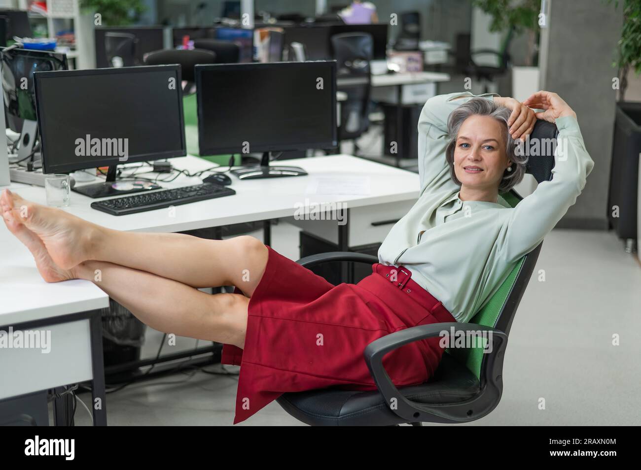 Mature Caucasian Woman Took Off Her Shoes And Put Her Feet On The
