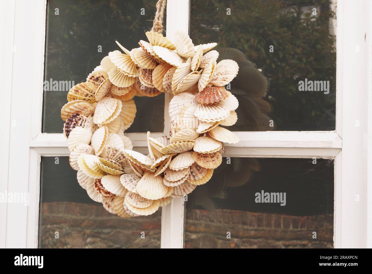 A decoration of clam shells on a front door, of a house, in the coastal ...