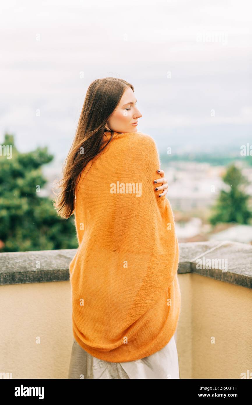 Romantic portrait of beautiful woman on the balcony under the summer ...