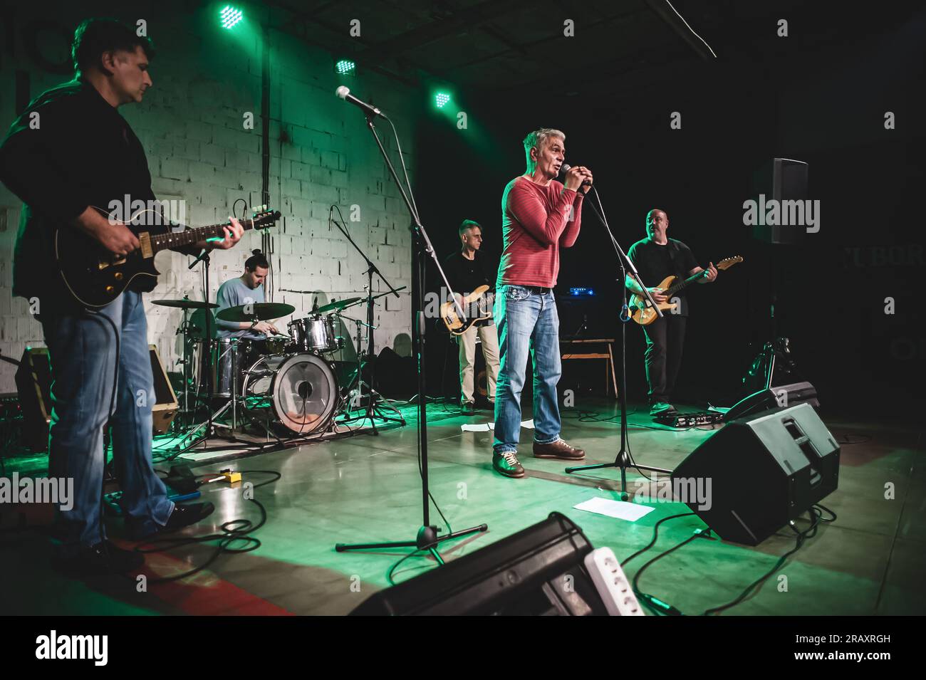 Punk rock music band group have live performance on a stage. Singer ...