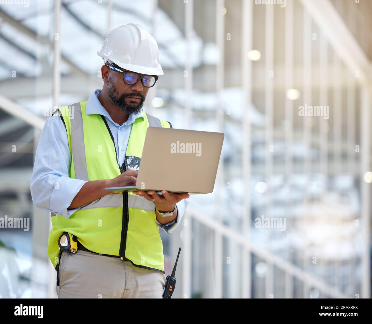 Architecture, research and laptop with black man in warehouse for ...