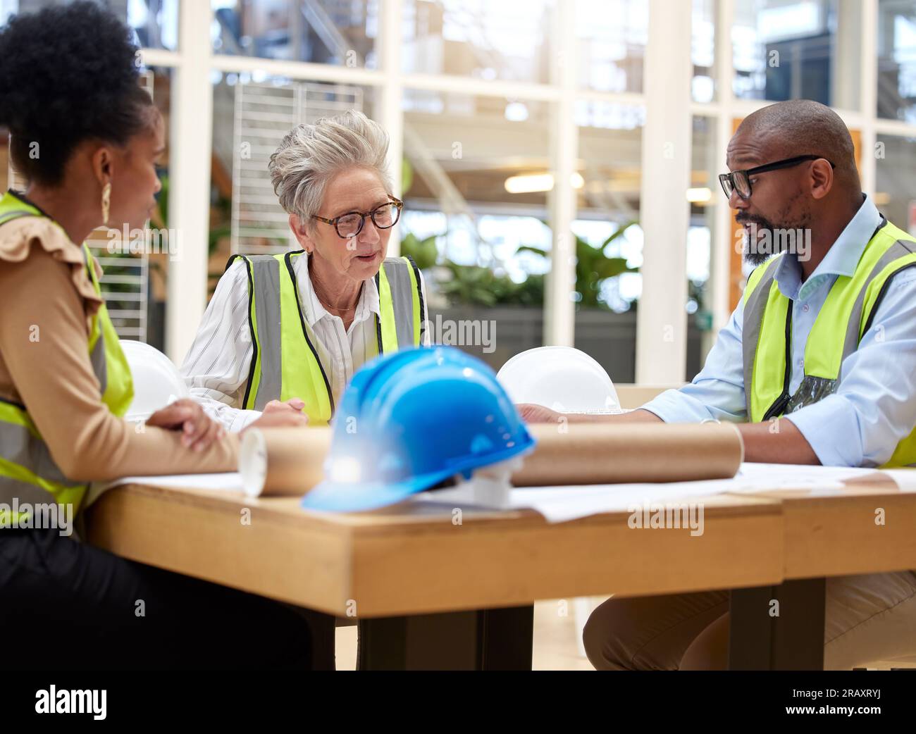 Meeting, planning and engineering people with blueprint for teamwork ...