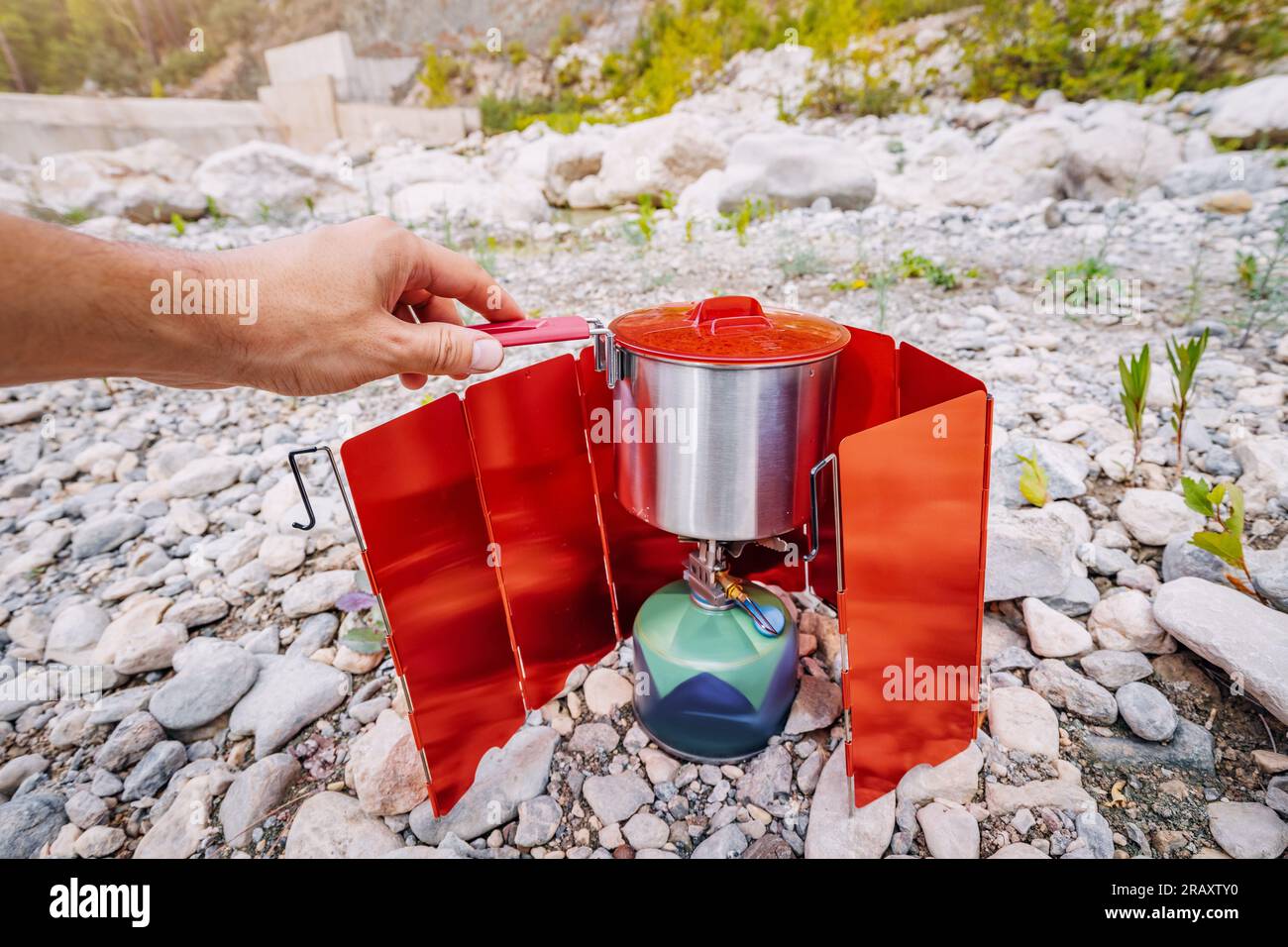 camping stove with wind screen shield. Cooking hiking food Stock Photo ...