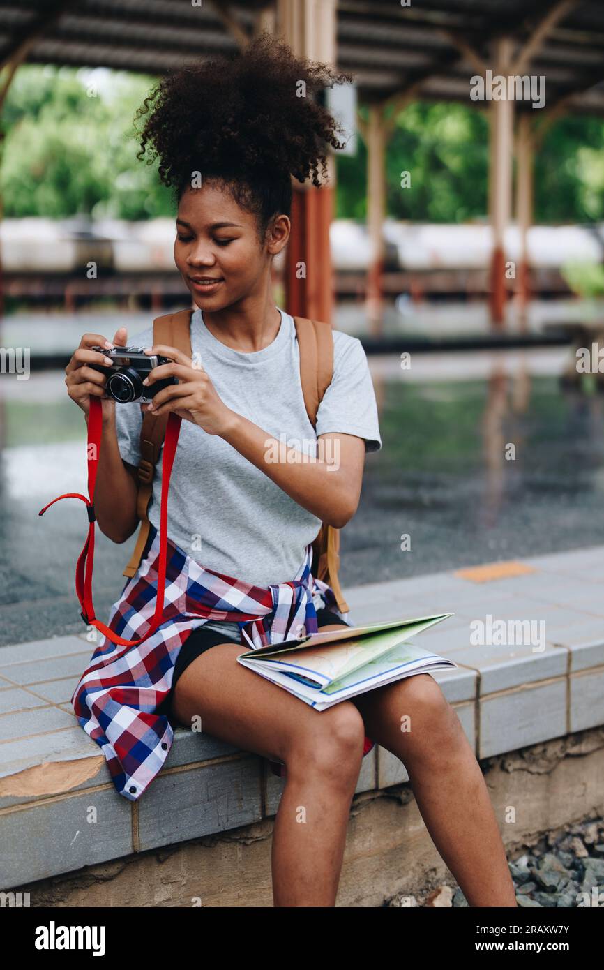Asian teenage girl african american traveling using a camera take a ...