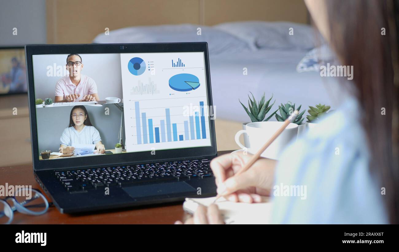 back view of people making video conference with colleague via laptop ...