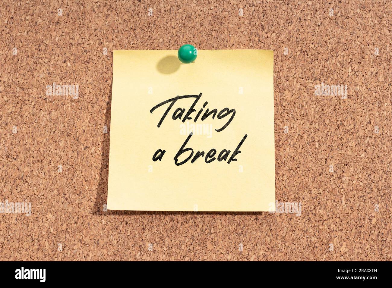 Yellow sticky note with message Taking a Break on cork board Stock ...