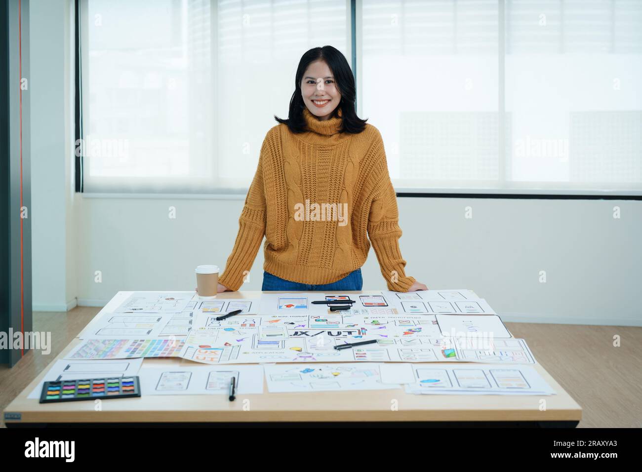 Group of asian creative team programing designers participate in all phases of the UX UI design ...