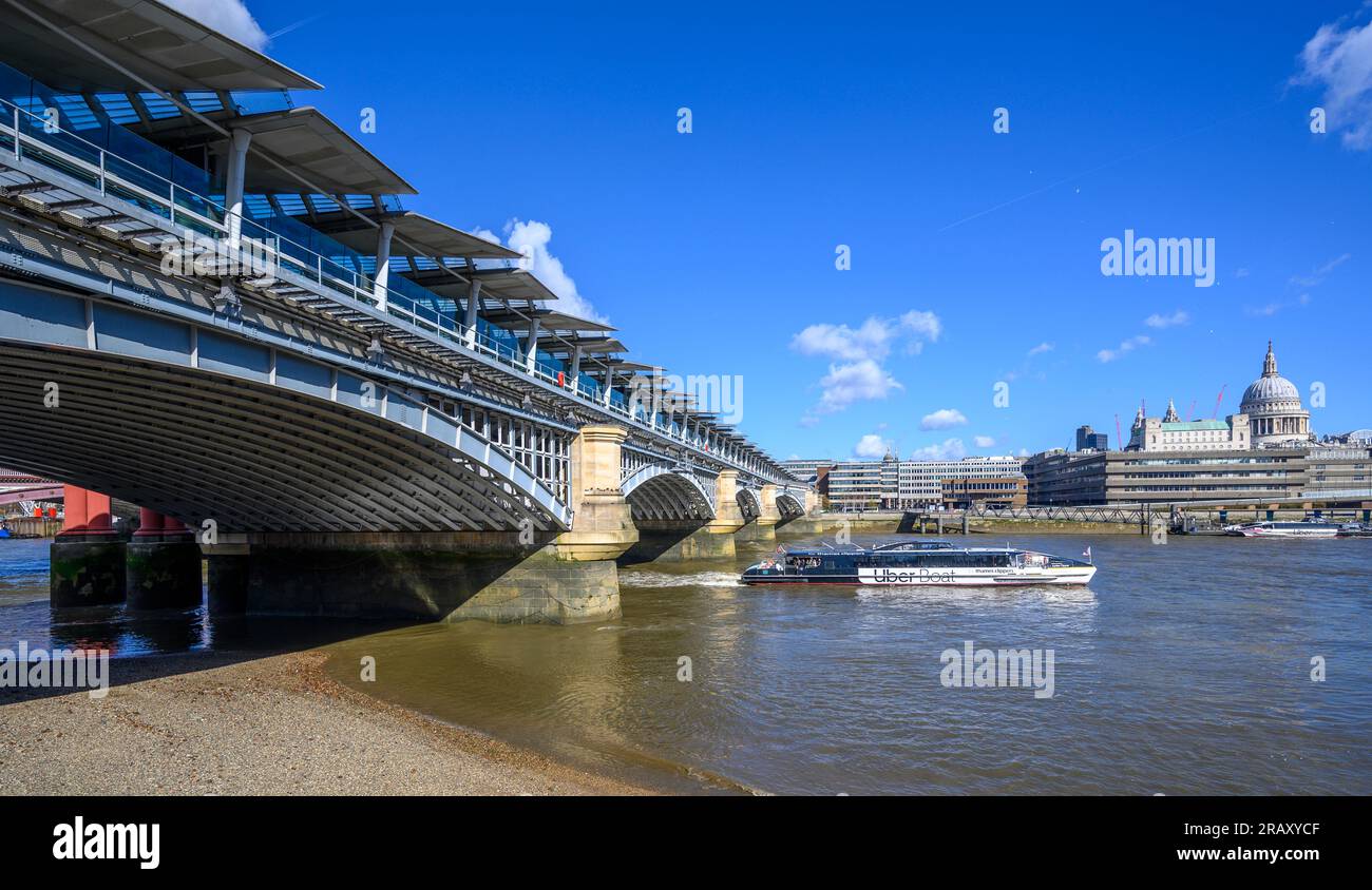 Thames Clippers Uber Boat passing beneath London Blackfriars bridge ...