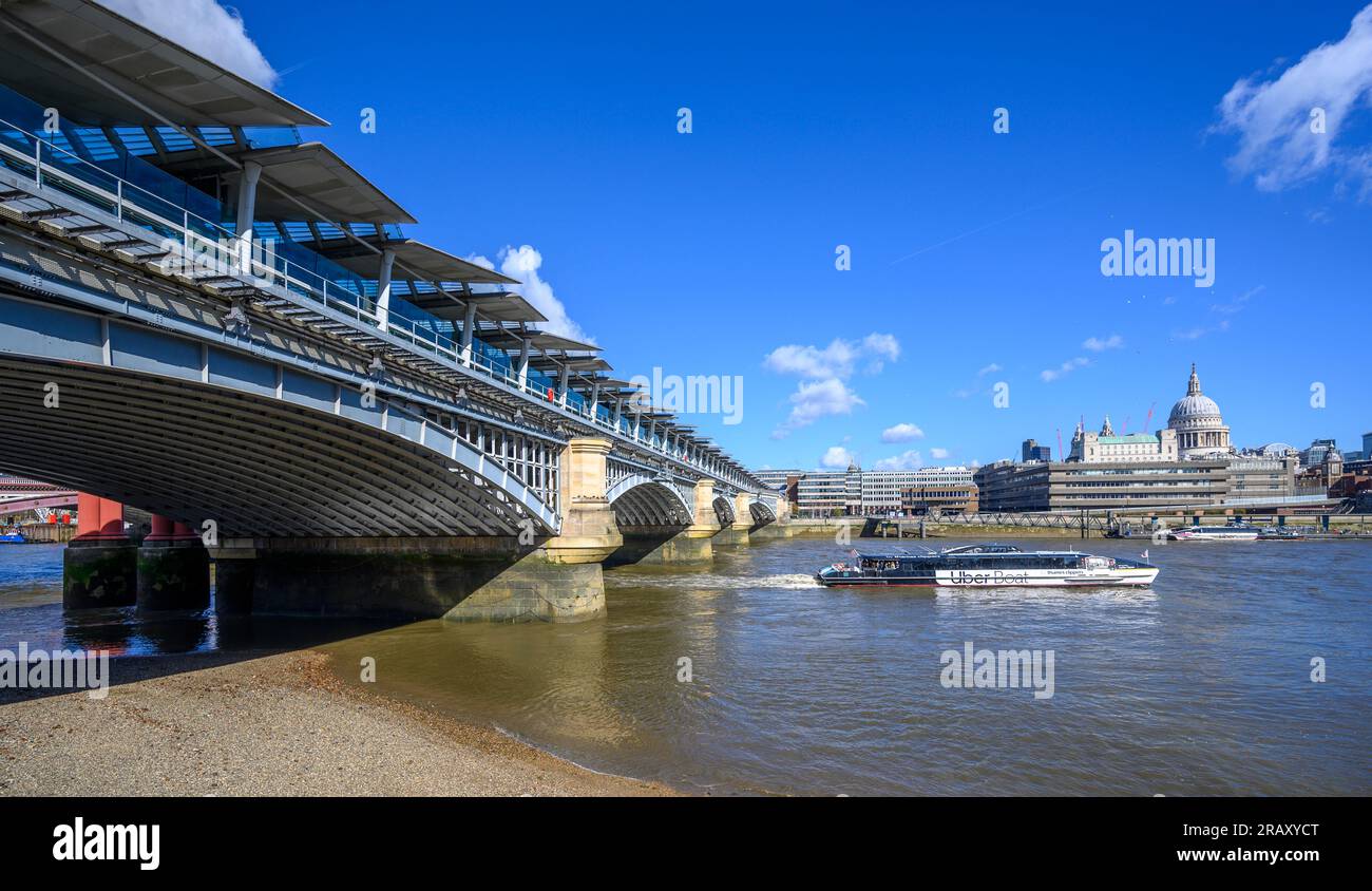 Thames Clippers Uber Boat passing beneath London Blackfriars bridge ...
