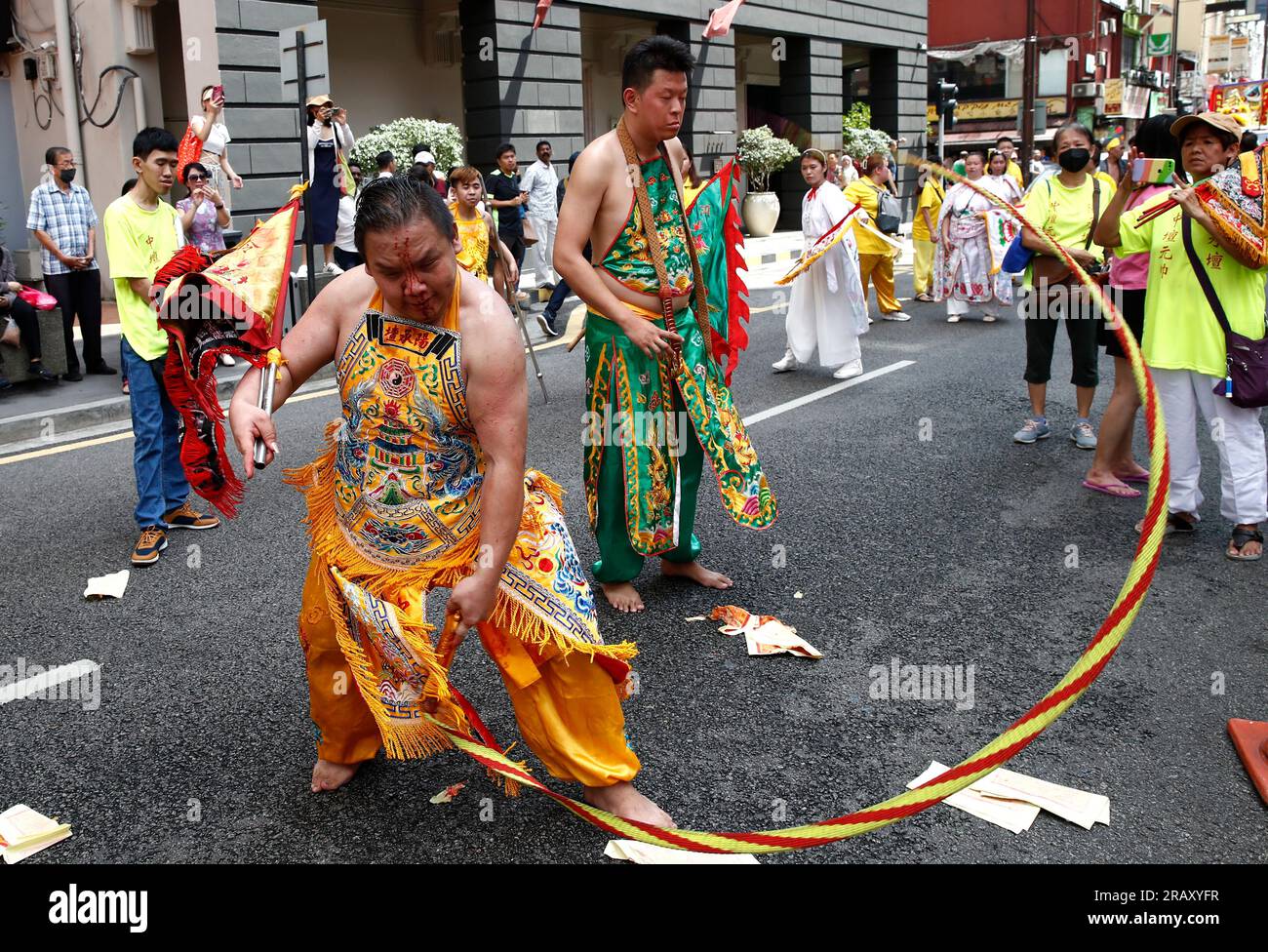 Devotees take part at a street procession during the Guan Ping festival ...