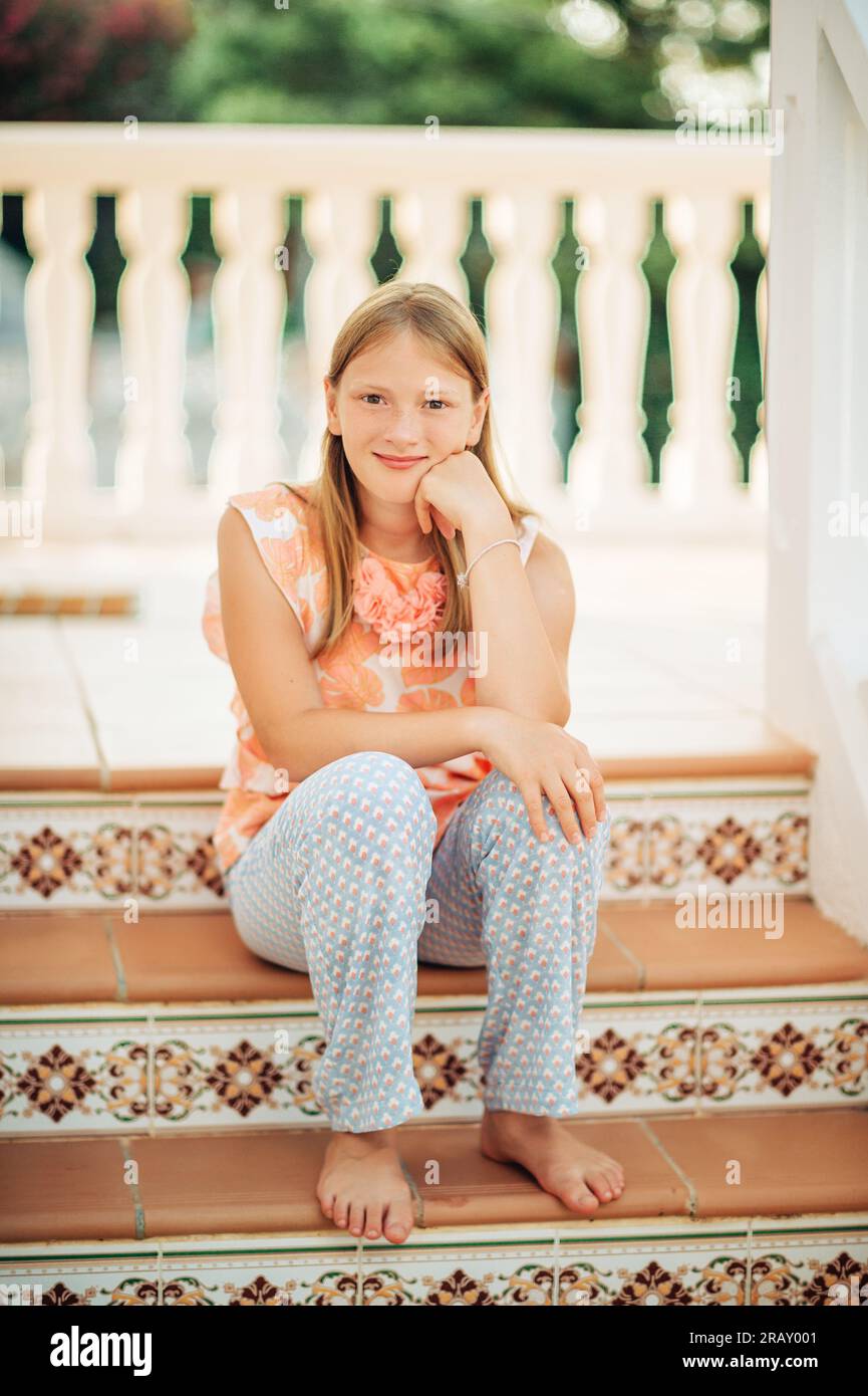 Outdoor portrait of beautiful young girl sitting on stairs Stock Photo ...