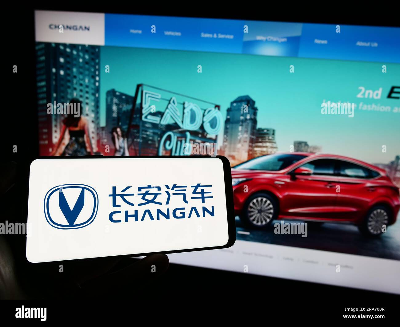 Person holding mobile phone with logo of Chinese company Changan ...