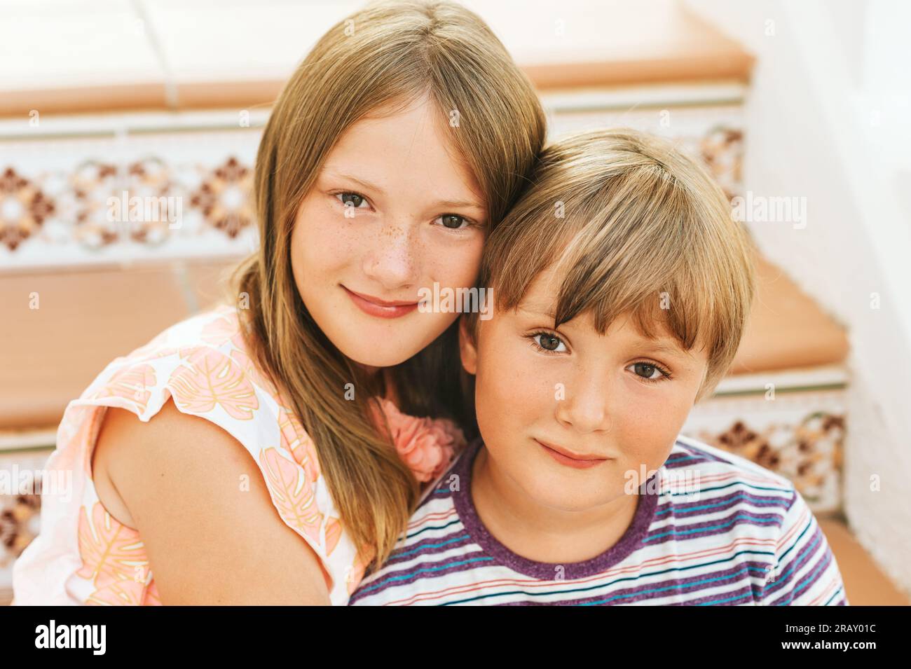 Outdoor summer portrait of two funny kids, small brother and big sister ...