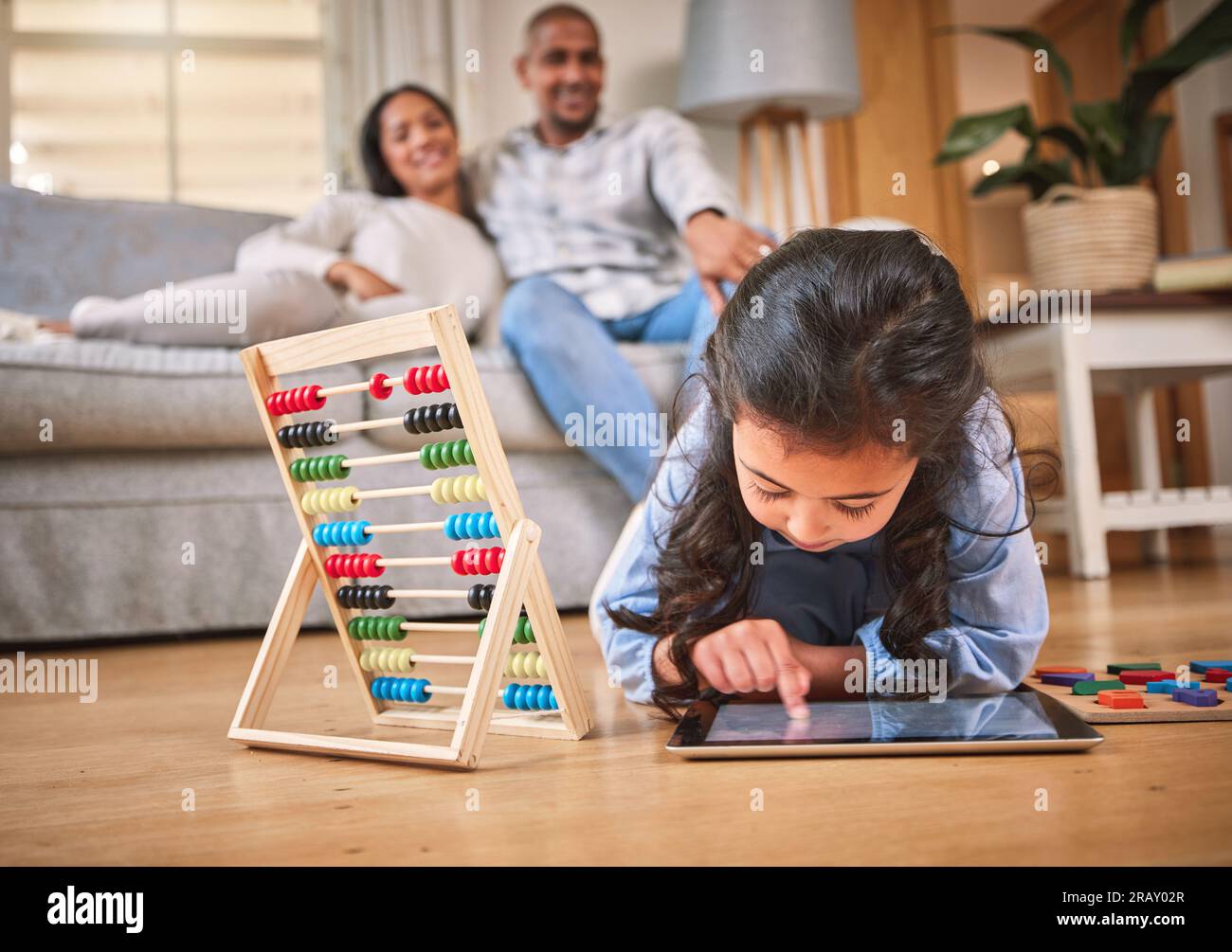 Child, toys for learning and tablet for education in family home with ...