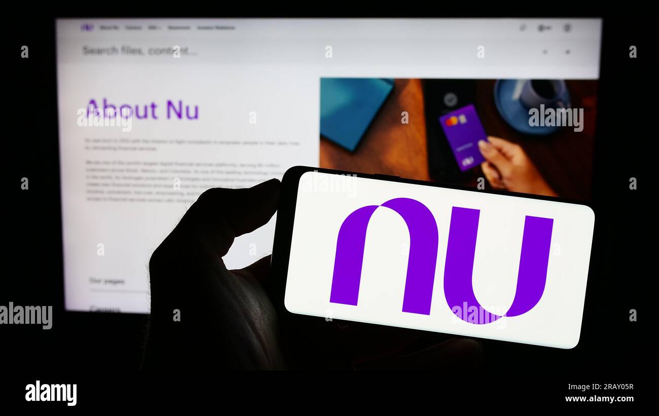 Person holding cellphone with logo of Brazilian company Nu Pagamentos ...