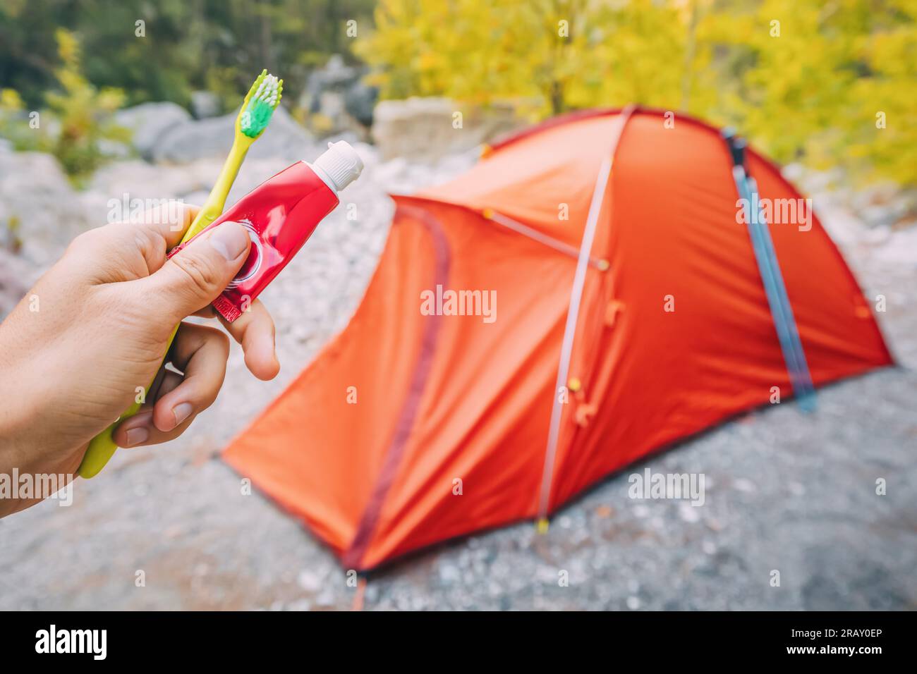 tooth brush and toothpaste at a camping site against the background of ...