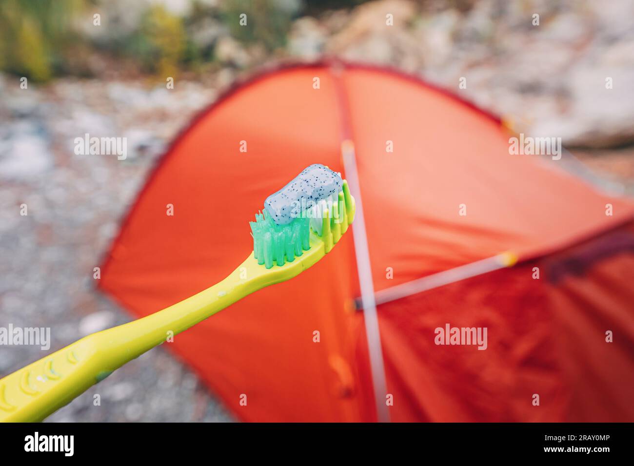 tooth brush and toothpaste at a camping site against the background of ...
