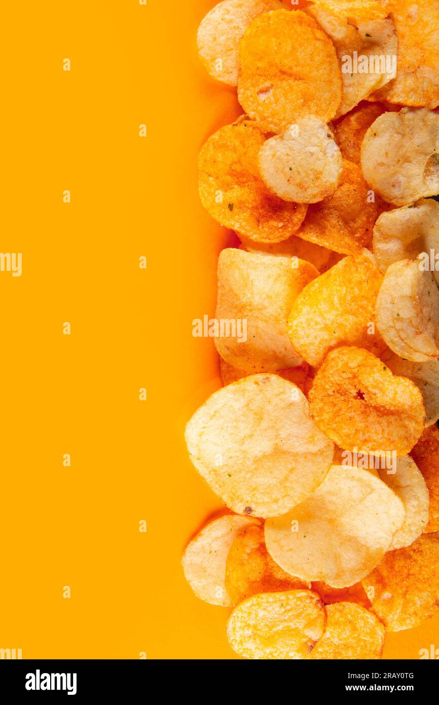 Border of potato chips isolated on orange colored background ...