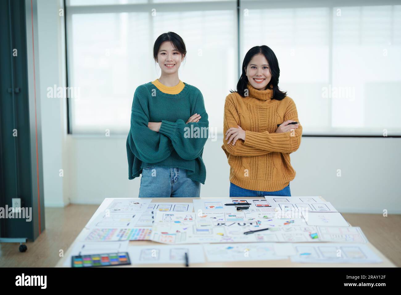 Group of asian creative team programing designers participate in all phases of the UX UI design ...