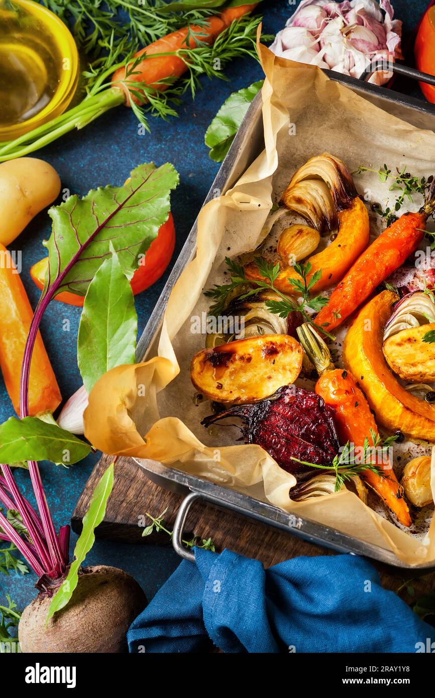 Oven Roasted vegetables with garlic and herbs on the baking tray ...
