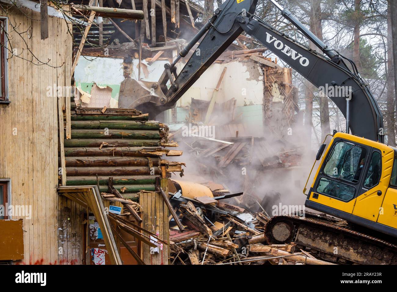 Demolition of an old wooden log house with a Volvo excavator ...
