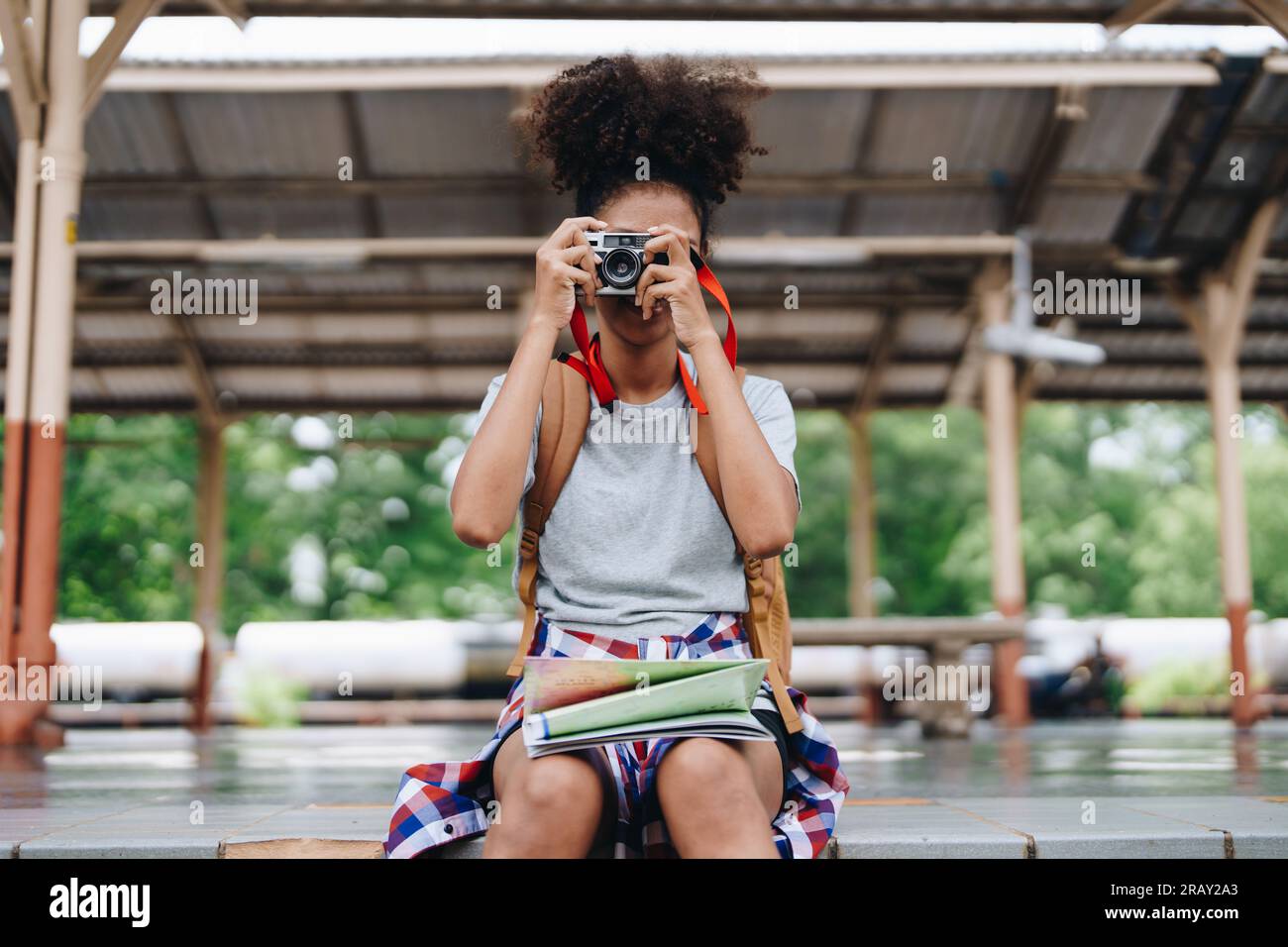 Asian teenage girl african american traveling using a camera take a ...