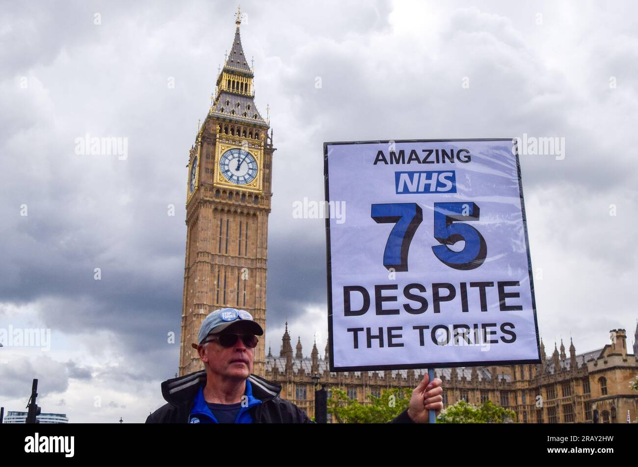 London, UK. 5th July 2023. An anti-Tory activist celebrates 75 years of ...