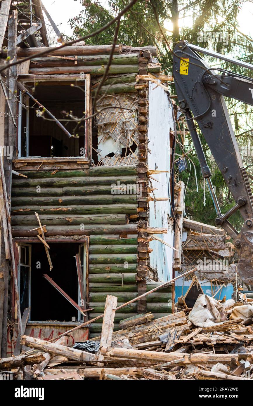 Broken wall of an old wooden house. Demolition of a two-story building ...