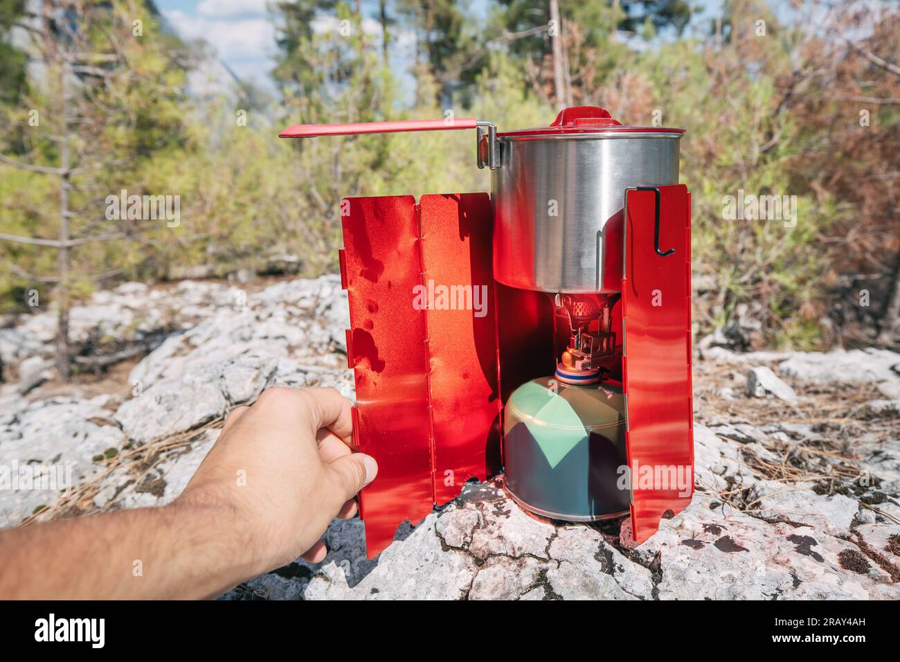 camping stove with wind screen shield. Cooking hiking food Stock Photo ...