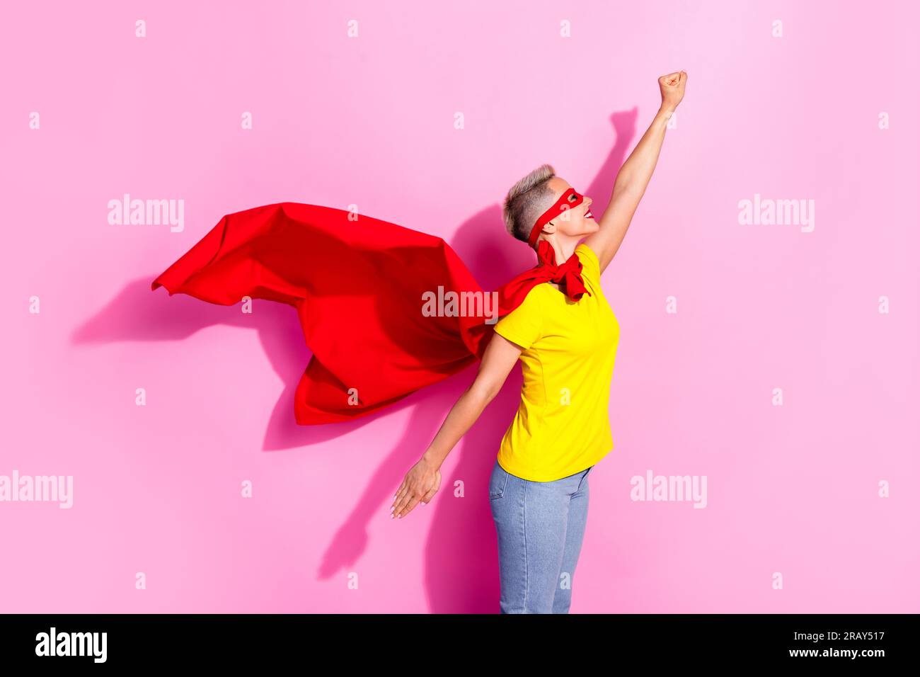Profile portrait of positive super girl raise arm fist fly empty space ...