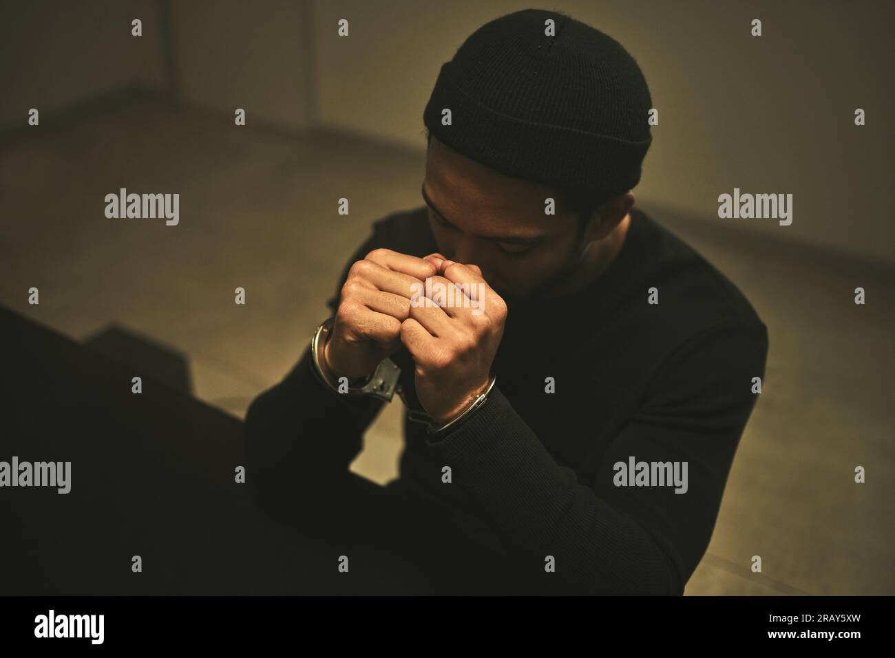 Interrogation, worry and criminal with handcuffs in jail for ...