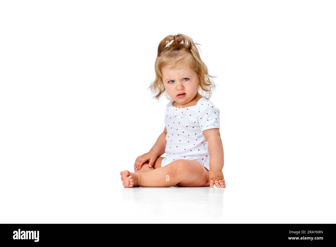 Questioning funny face. Cute, beautiful little girl, toddler sitting on ...