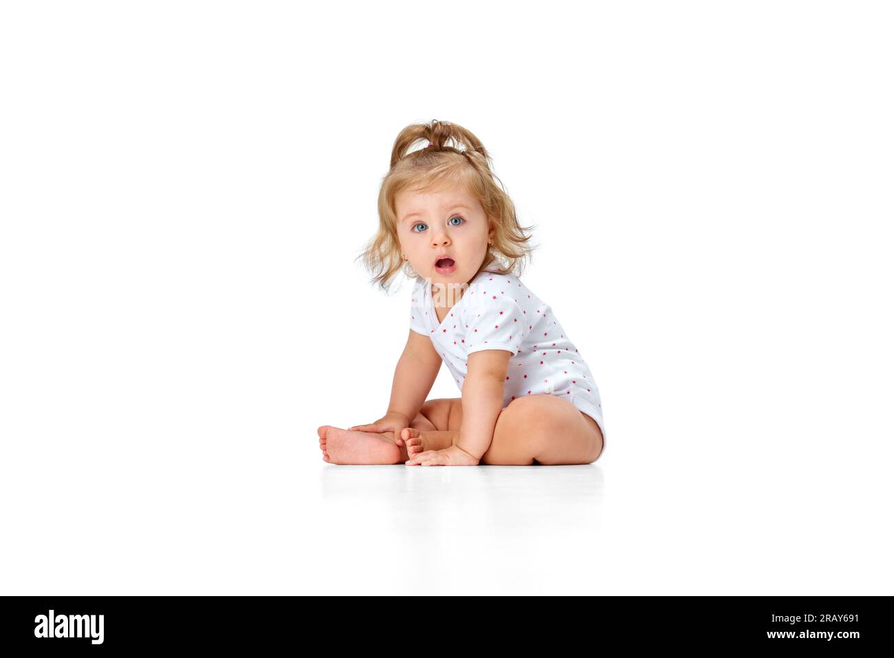 Curious little baby. Cute little girl, toddler sitting on floor and ...