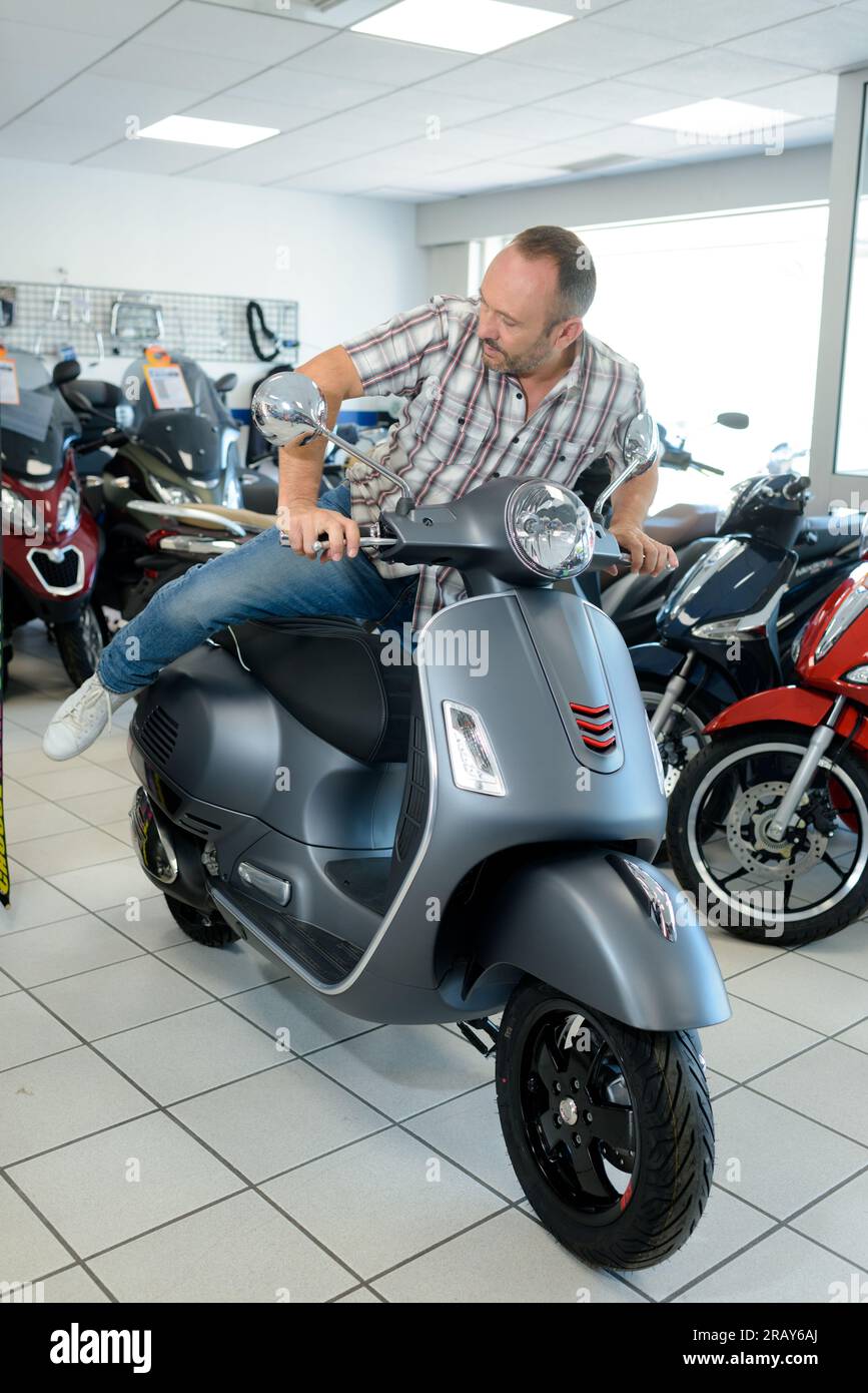 man in a scooter store Stock Photo - Alamy