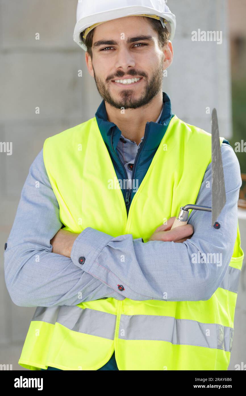 jolly smiling constructor wearing helmet Stock Photo - Alamy
