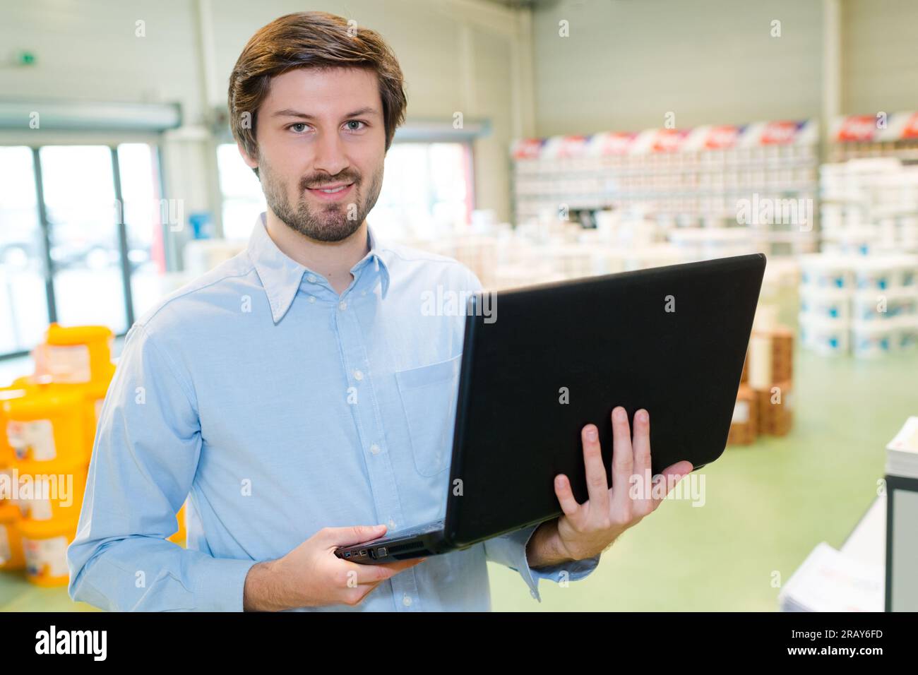 worker typing at a computer in a stockroom Stock Photo - Alamy