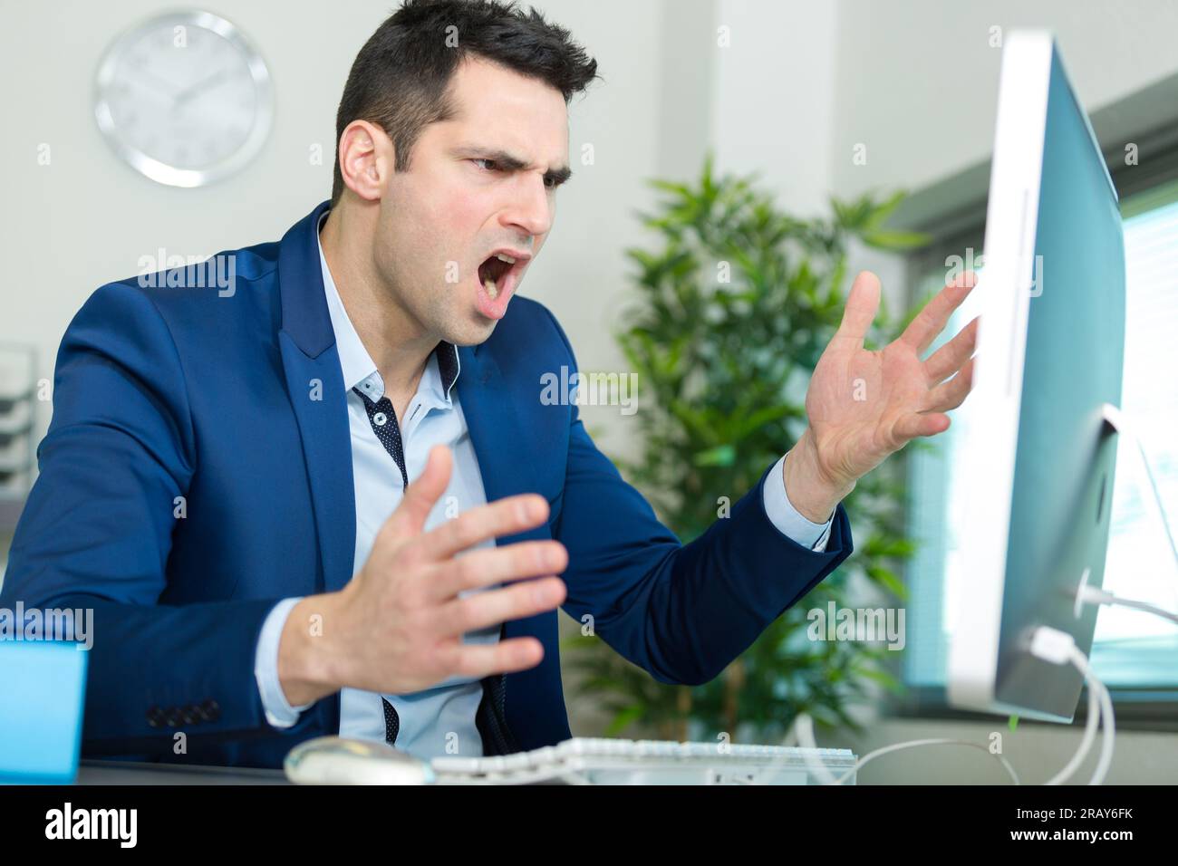businessman shouting and gesturing at computer screen Stock Photo - Alamy