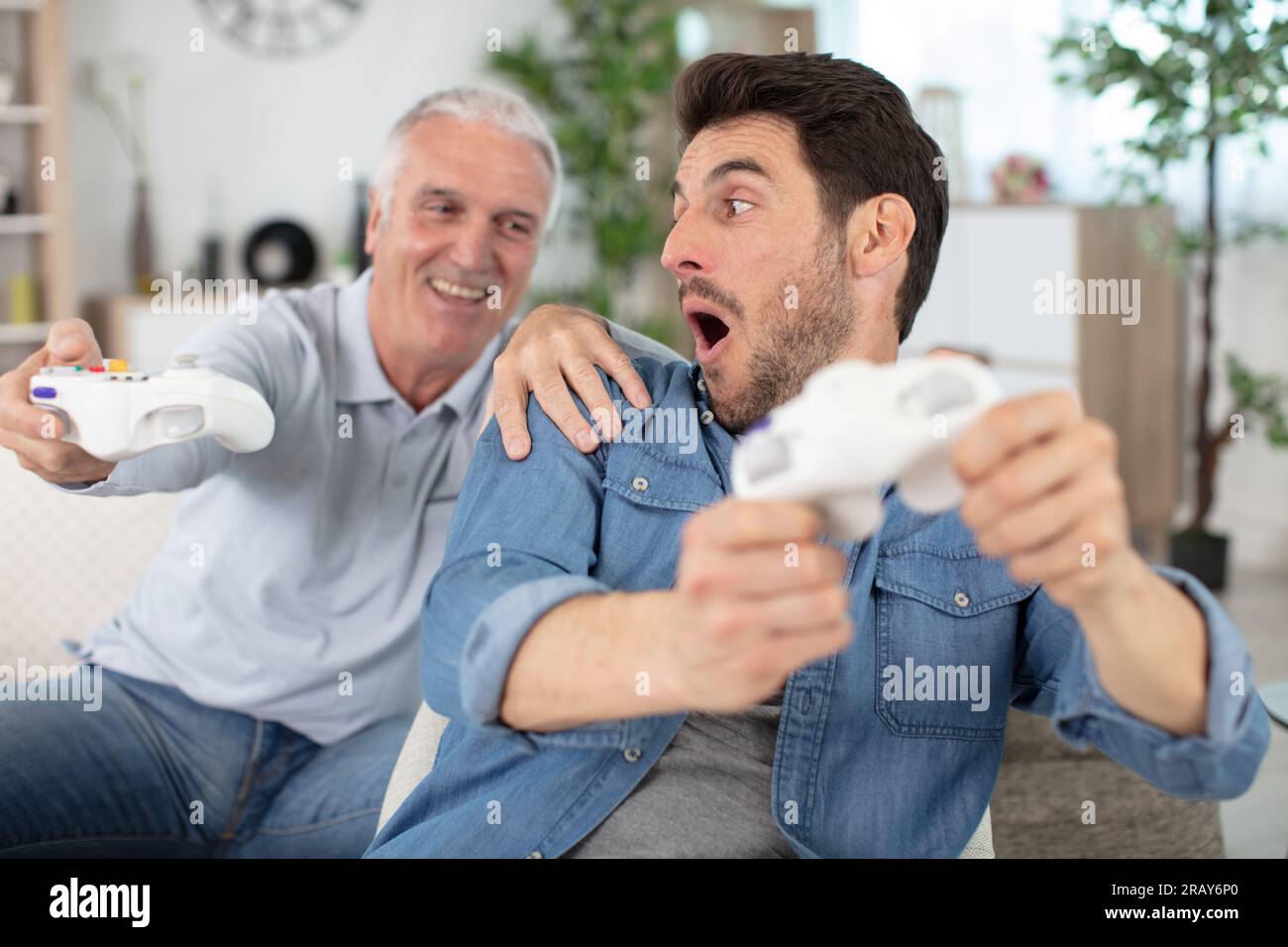 men interacting while playing fun computer game Stock Photo - Alamy