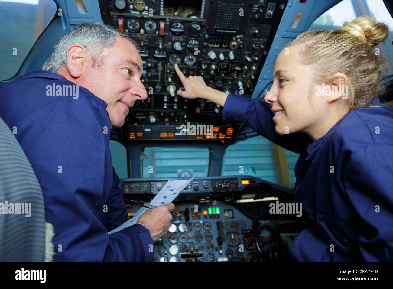 two modern aircraft engineers in cockpit Stock Photo - Alamy