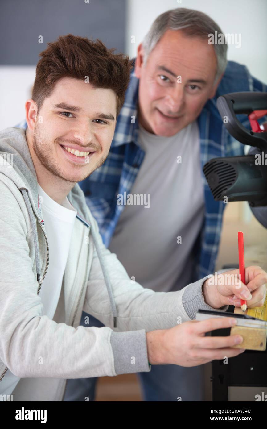 male carpenter apprentice smiling at the camera Stock Photo - Alamy