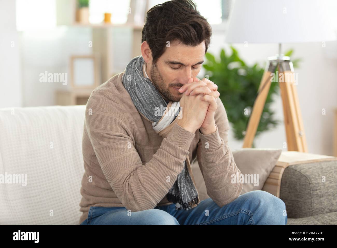 sad man with closed eyes praying with hope Stock Photo - Alamy
