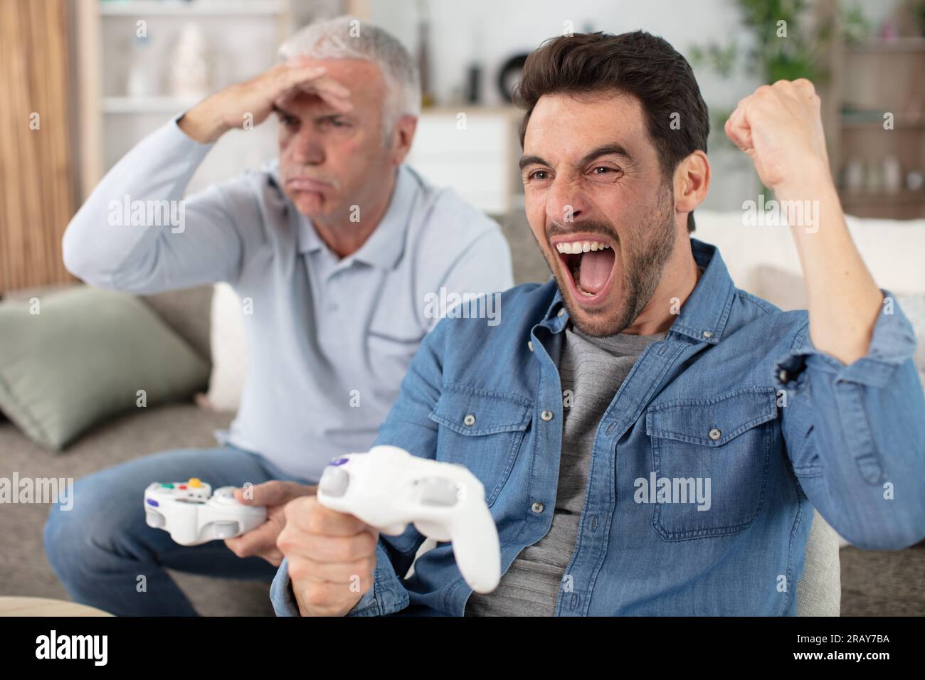 happy family playing video games Stock Photo - Alamy