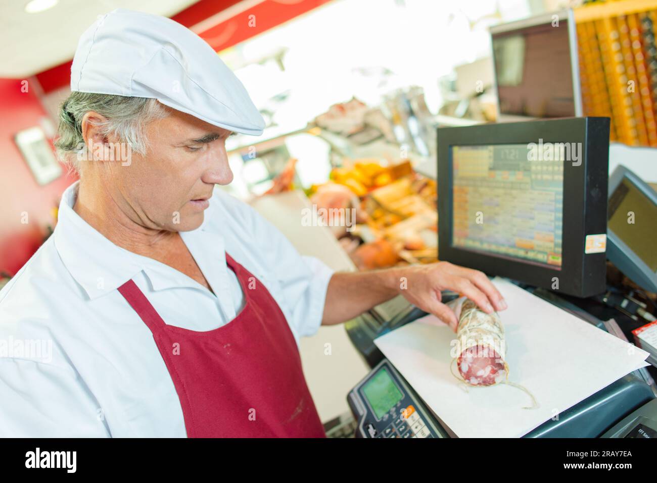 a butcher is weighing meat Stock Photo - Alamy