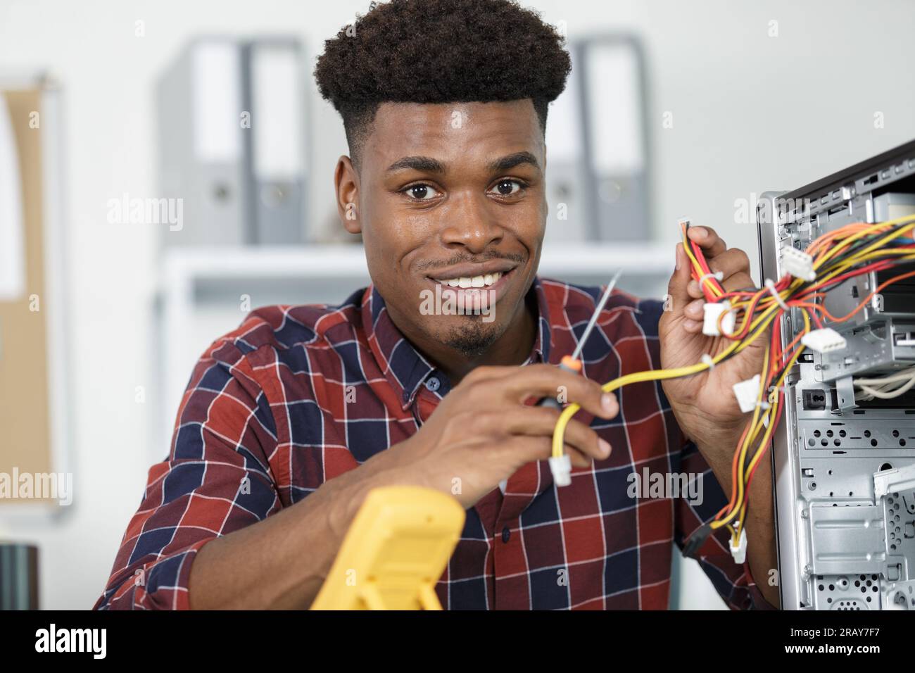 happy smiling pc repairman is repairing the computer Stock Photo - Alamy