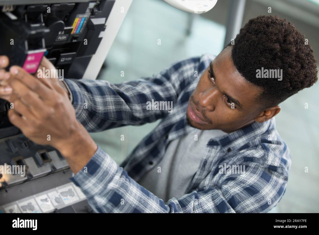 technician is checking and changing the printer equipment cartridges ...