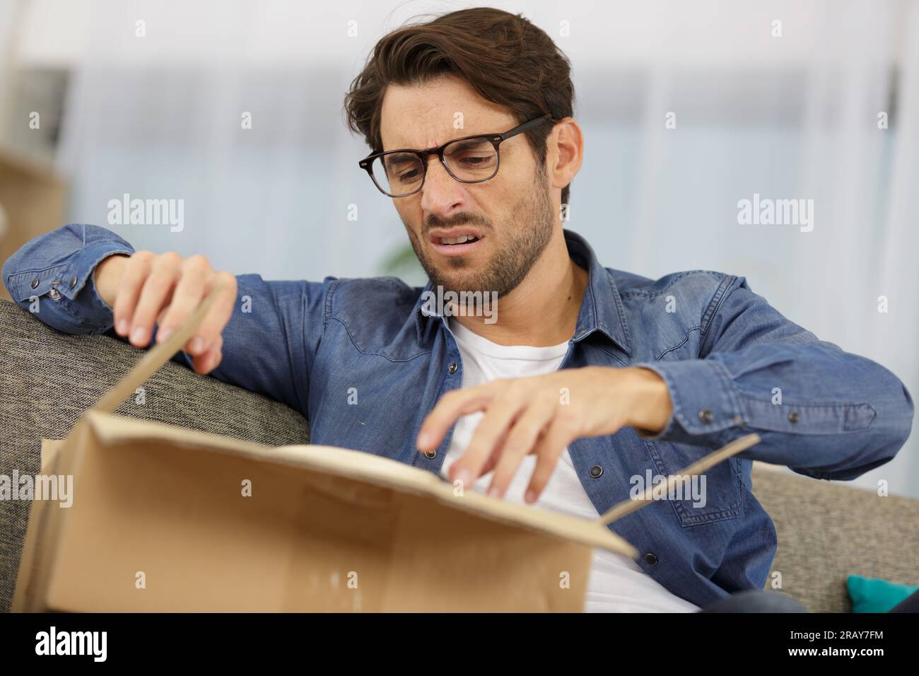 upset man with the wrong delivery Stock Photo - Alamy