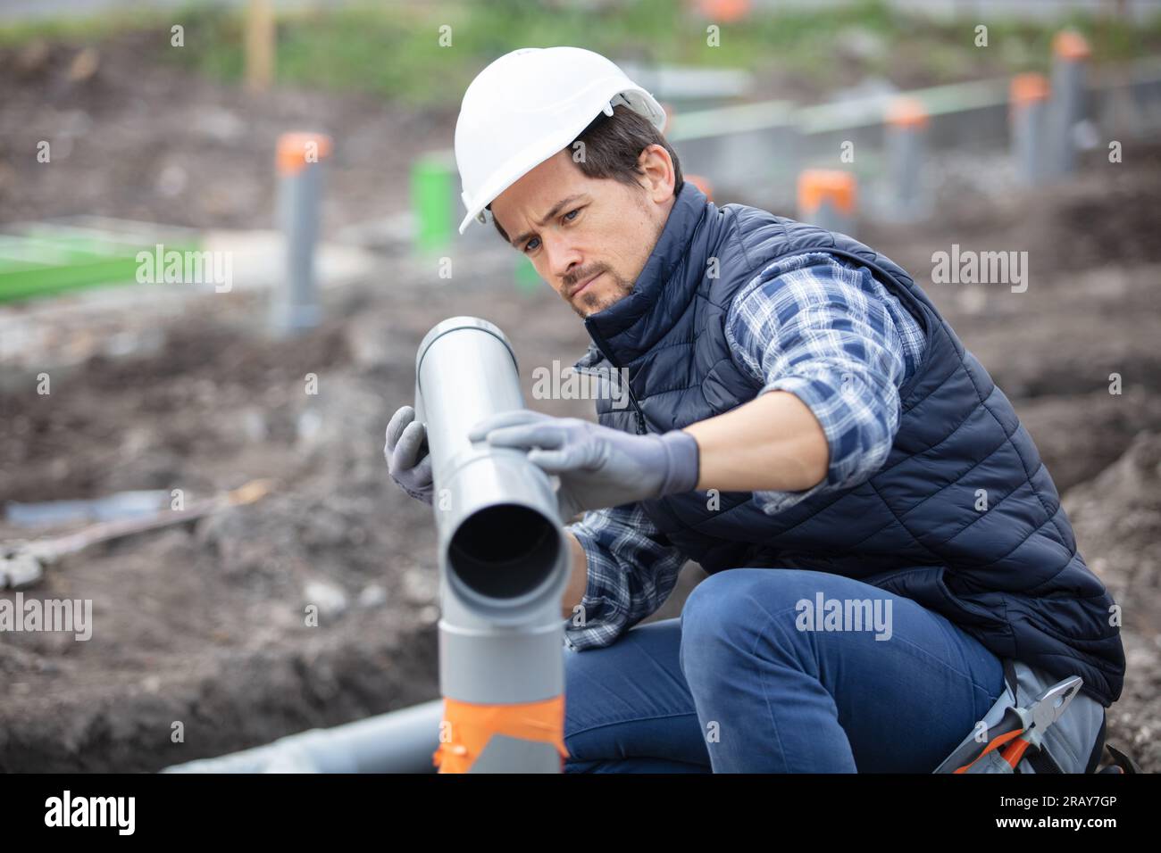 worker construction builder assembling pipe on foundation Stock Photo ...