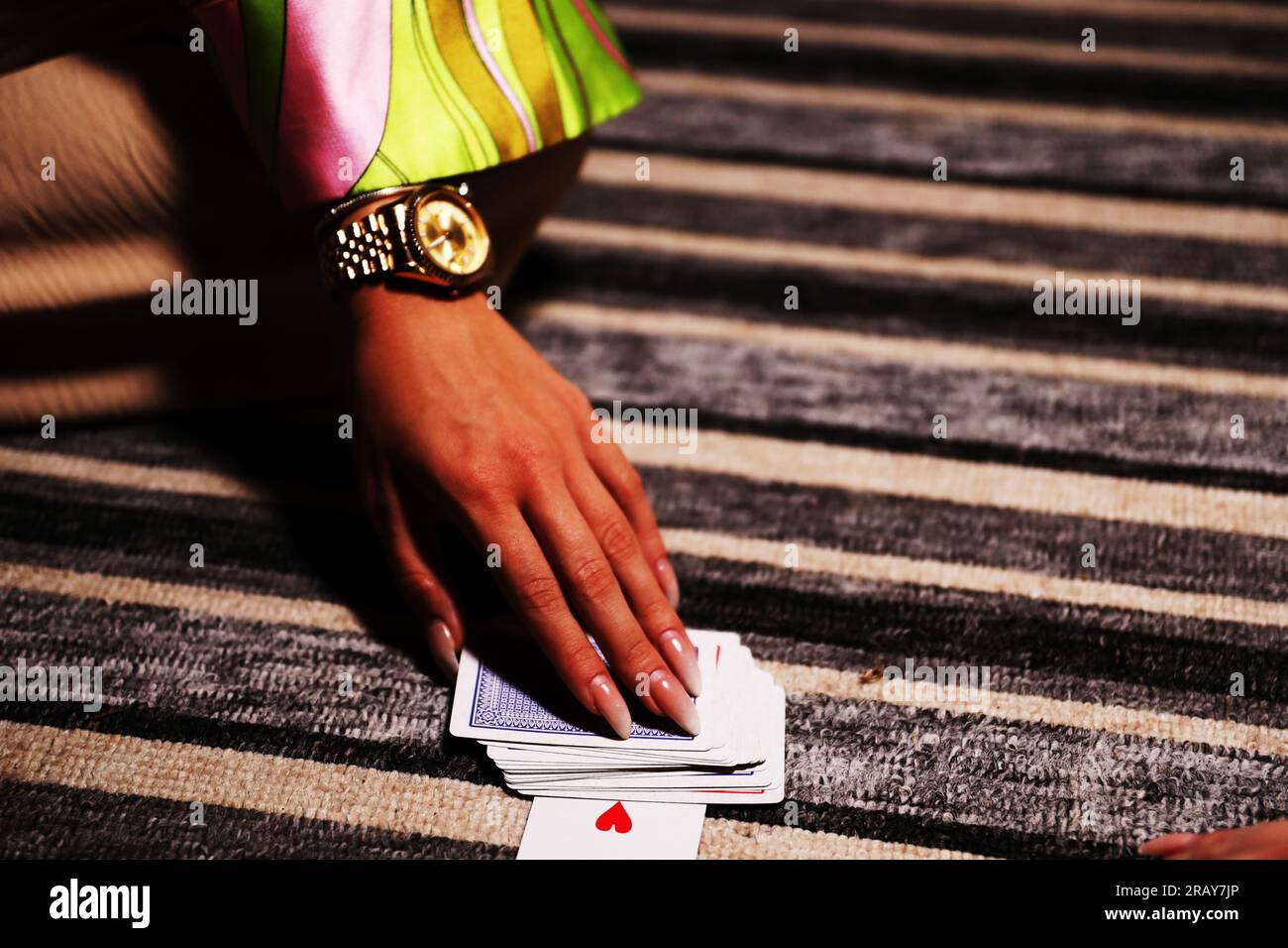 playing cards in a woman hand. Close-up of a player holding card in ...