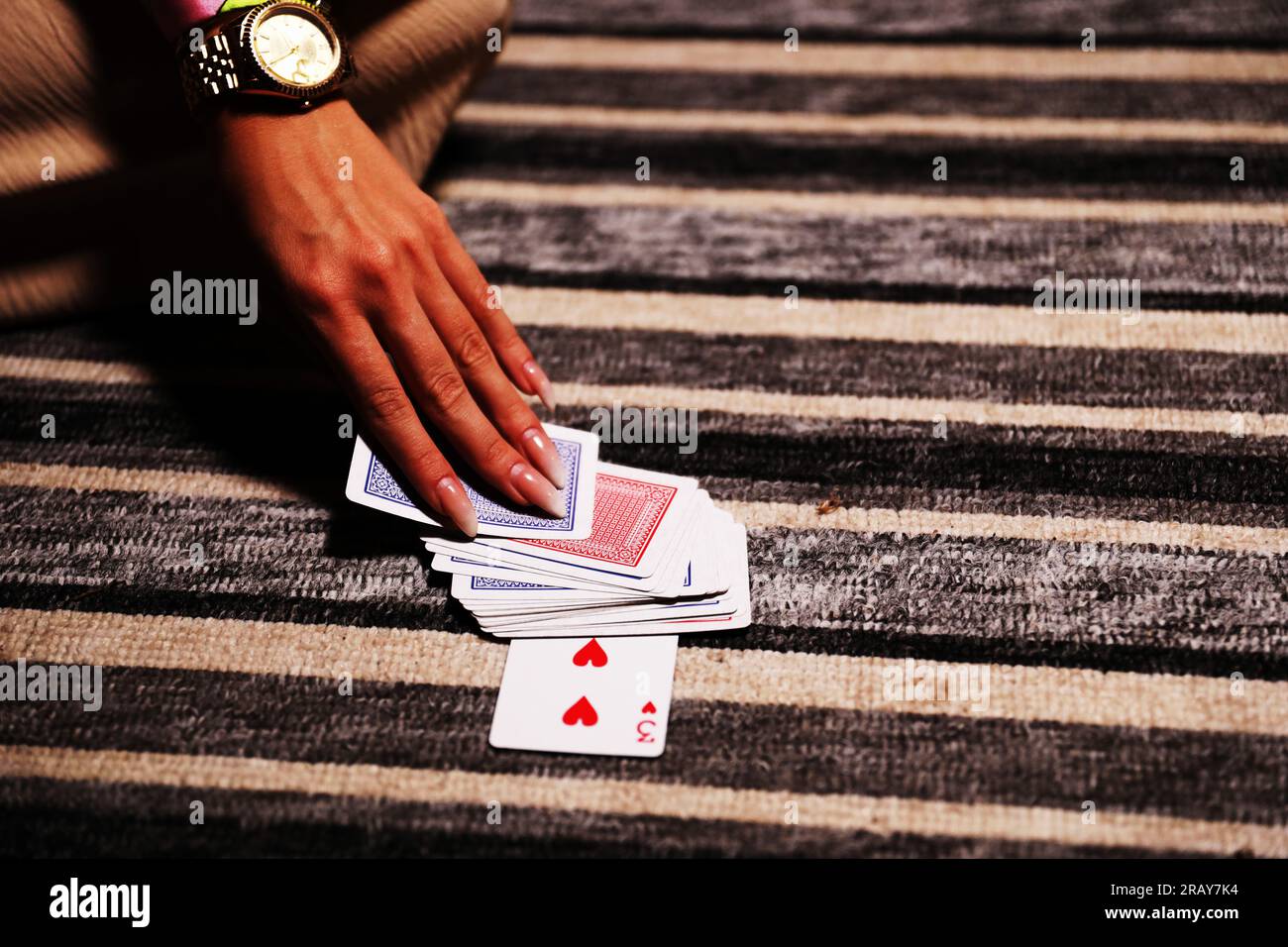 playing cards in a woman hand. Close-up of a player holding card in ...